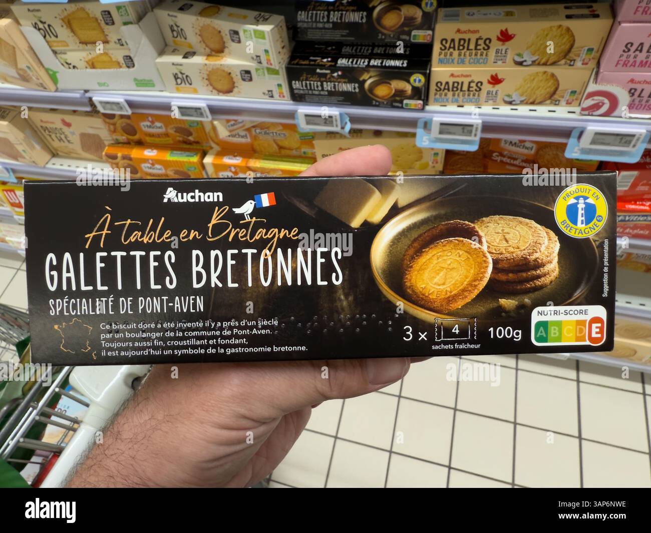 Hand holding a package of galettes bretonnes cookies from Auchan ...