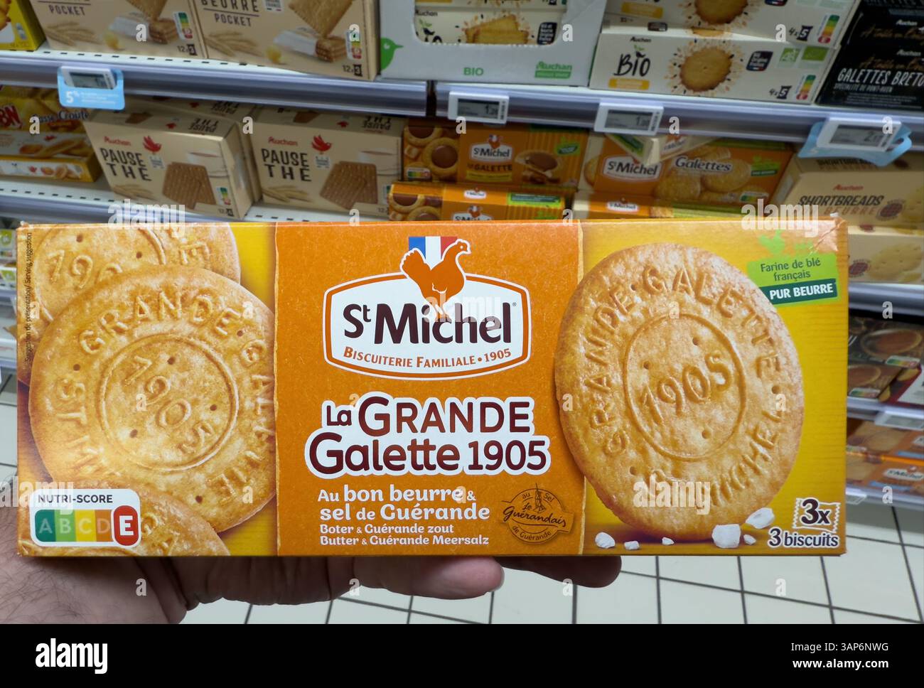 Hand holding a package of St Michel la Grande Galette 1905 biscuits in ...