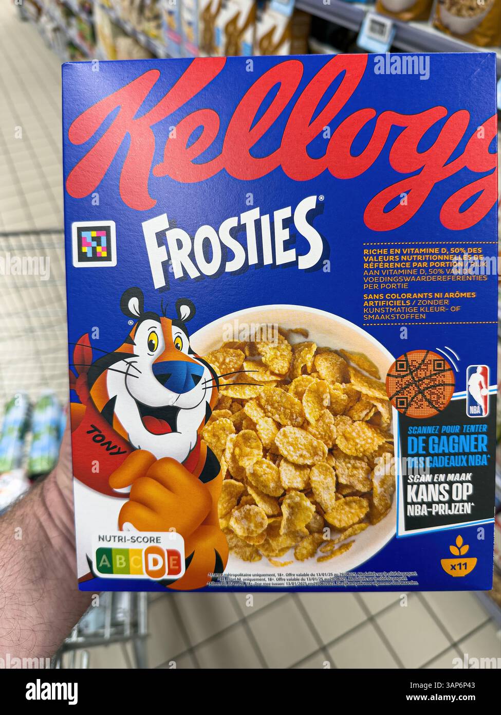 Close up of a customer holding a Kellogg's Frosties cereal box ...