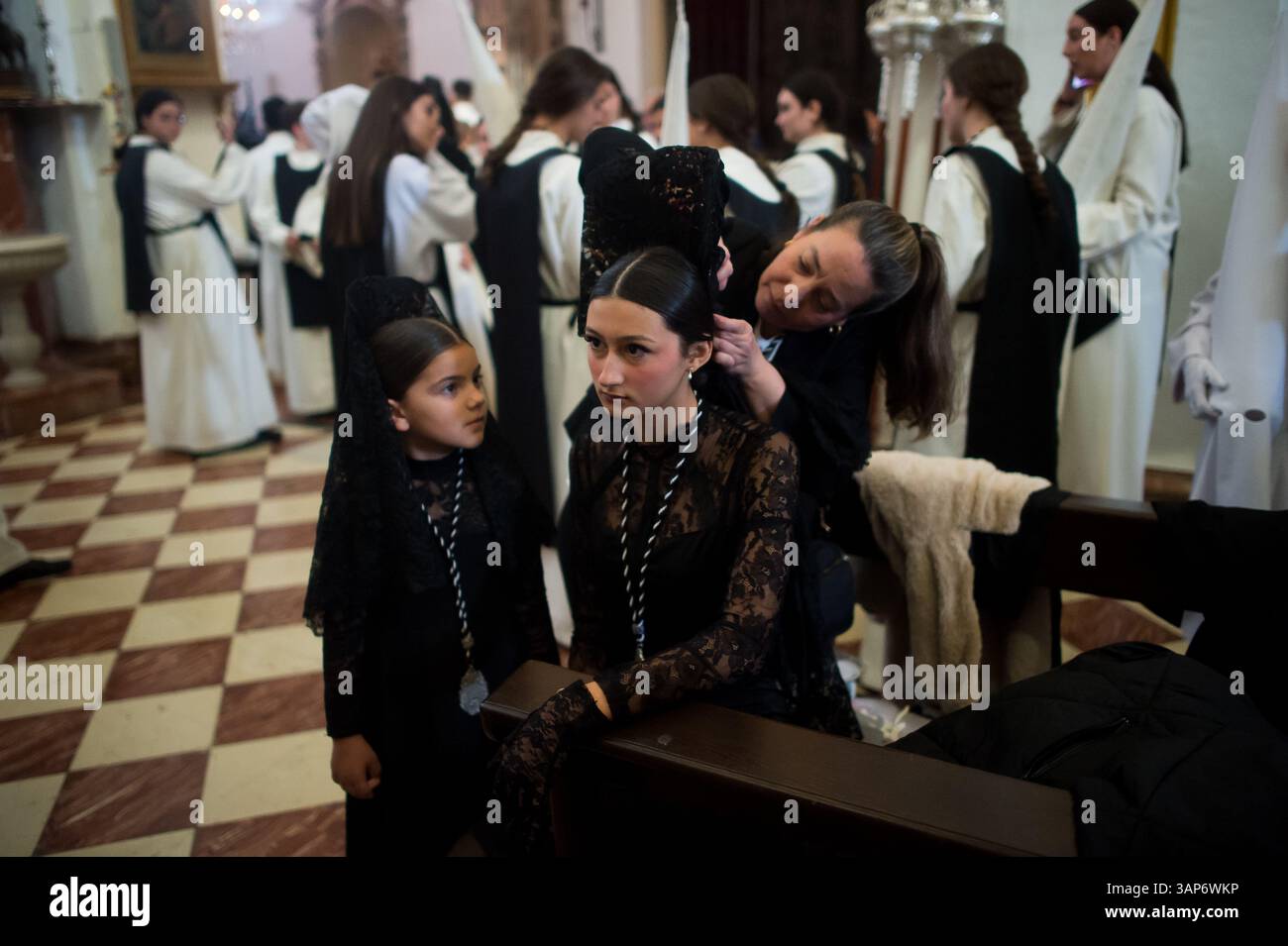 A woman from ‘Humiliacion y Estrella' brotherhood is seen adjusting the ...