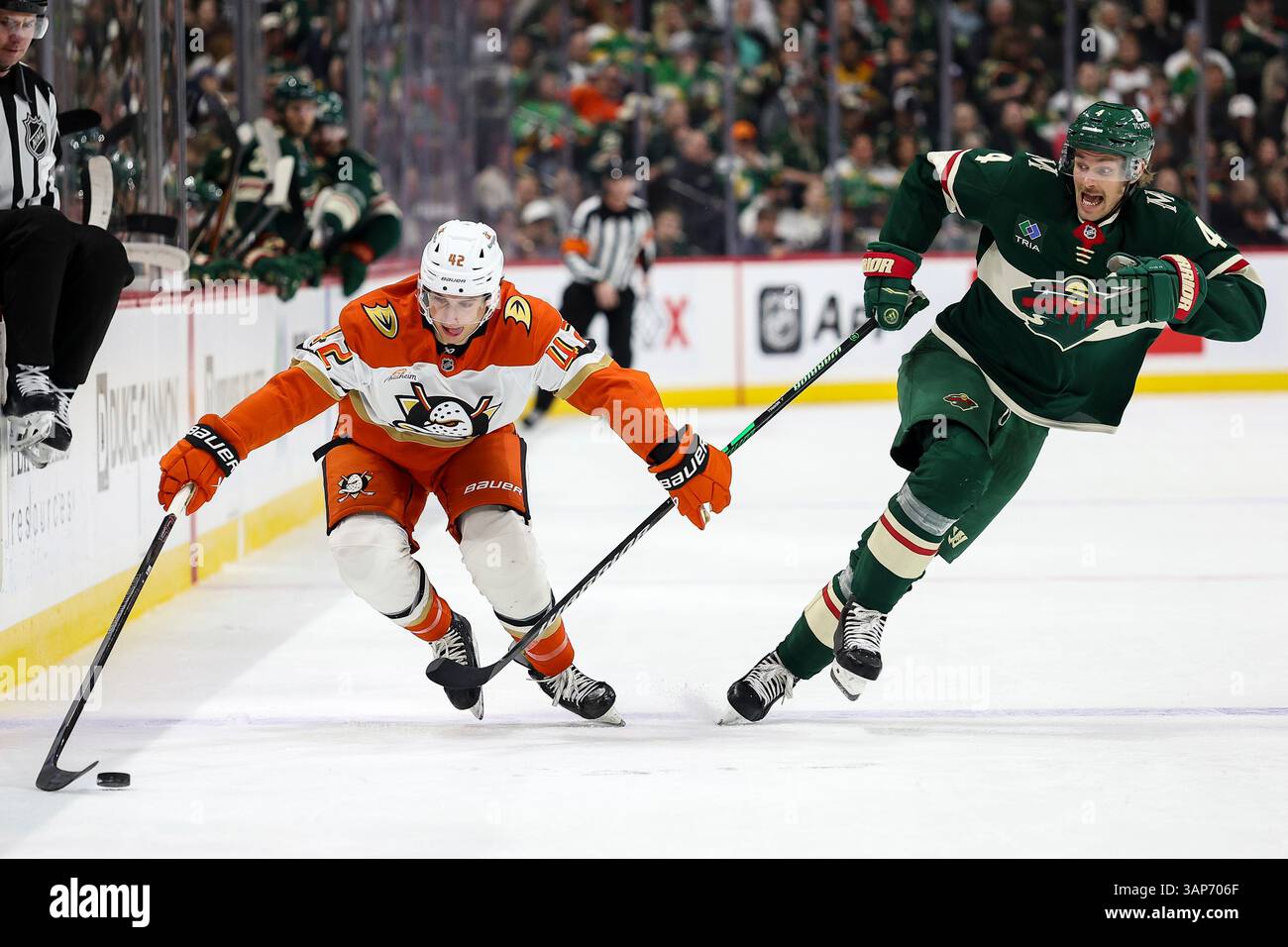 Anaheim Ducks center Tim Washe, left, skates with the puck alongside ...
