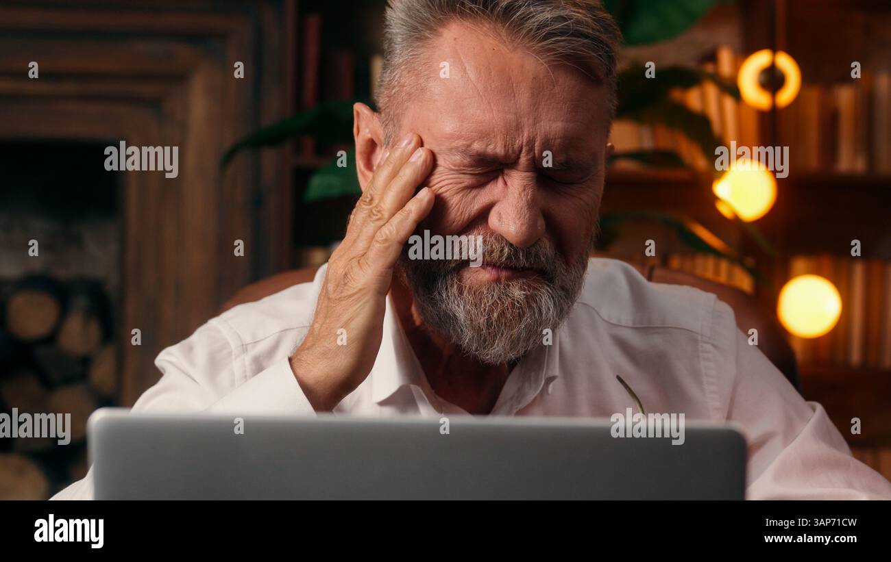 Tired exhausted elderly Caucasian man businessman rub eyes headache ...
