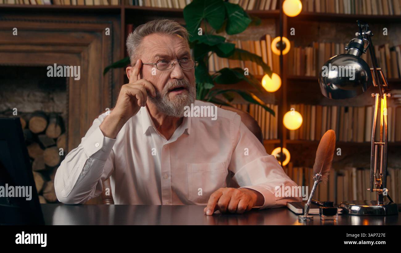 Old elderly Caucasian man thinking ponder new idea raise finger up ...