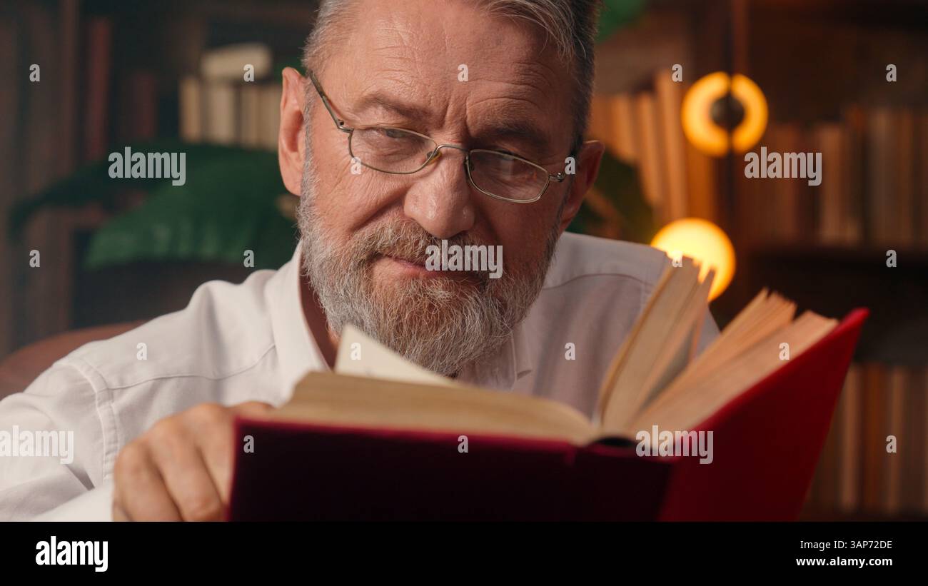 Wrinkled Caucasian man reading book turning pages textbook education ...