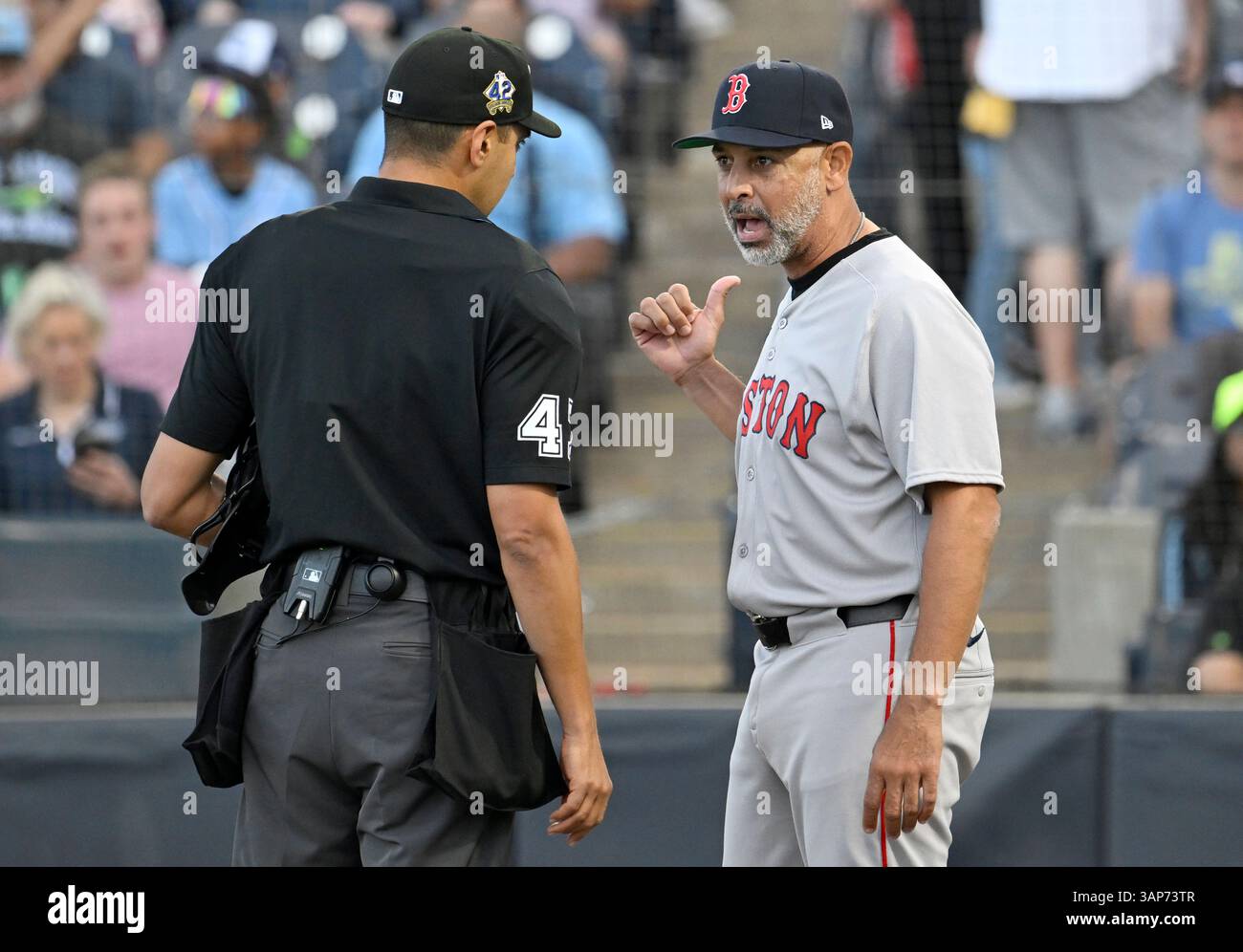 Boston Red Sox manager Alex Cora talks with umpire Gabe Morales during ...