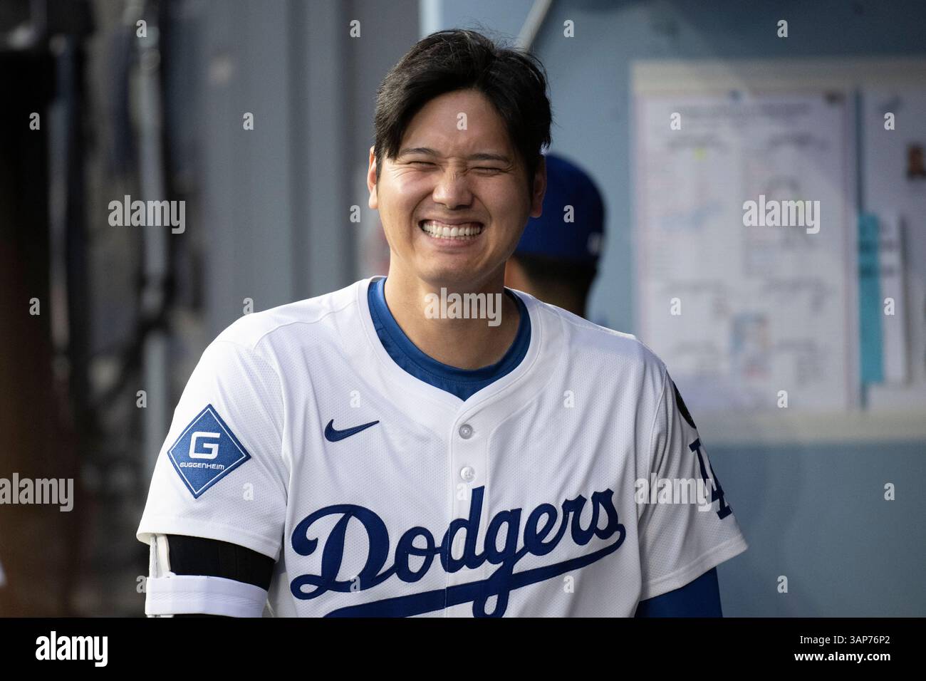 Los Angeles Dodgers' Shohei Ohtani smiles in the dugout during a ...