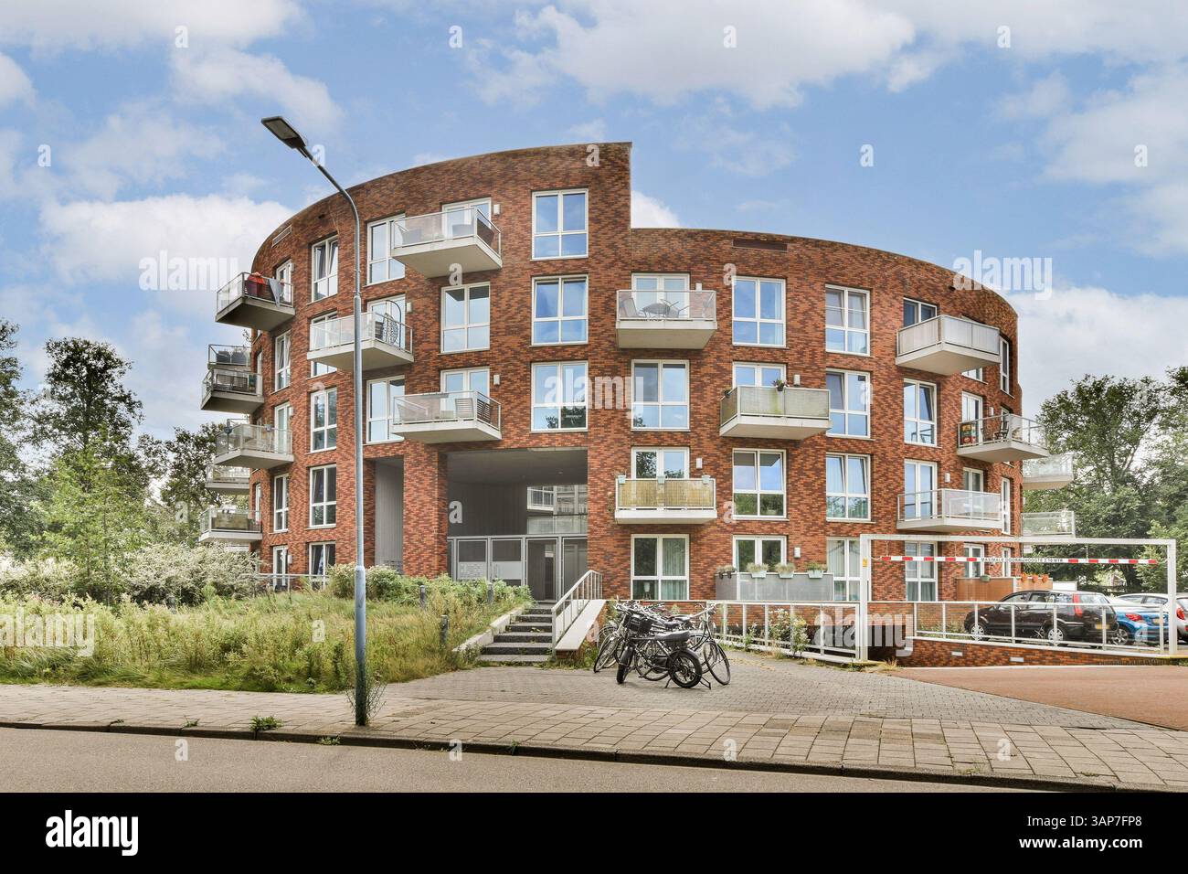 A contemporary building features unique balconies and large windows ...