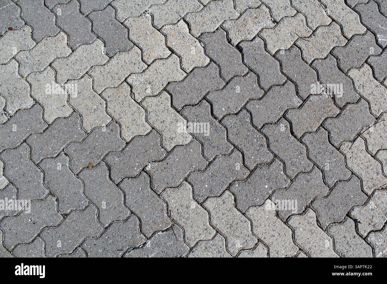 Grey interlocking paving stones close up abstract textured background ...