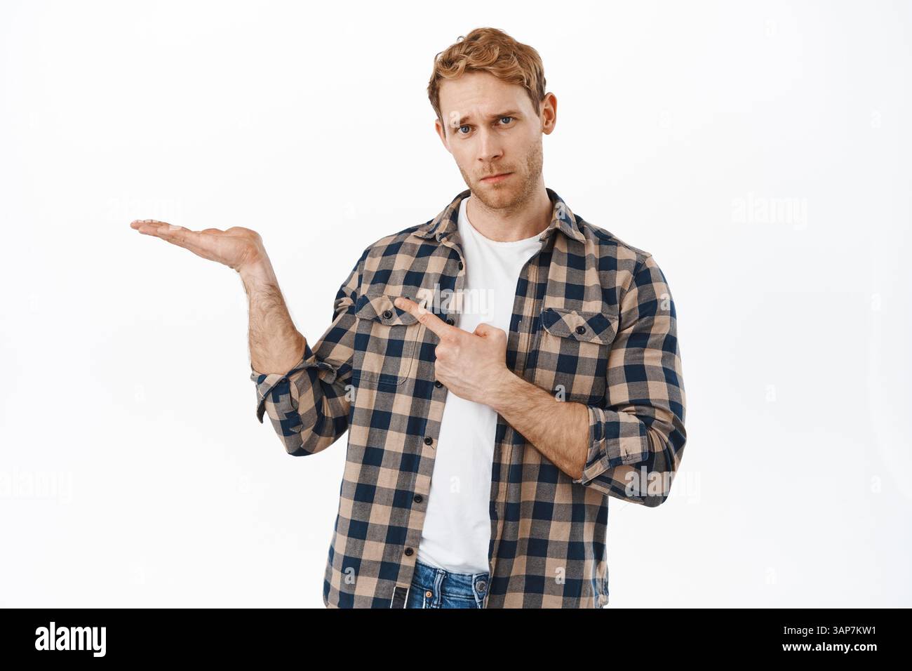 Have you seen this. Serious redhead man pointing at object on his open ...