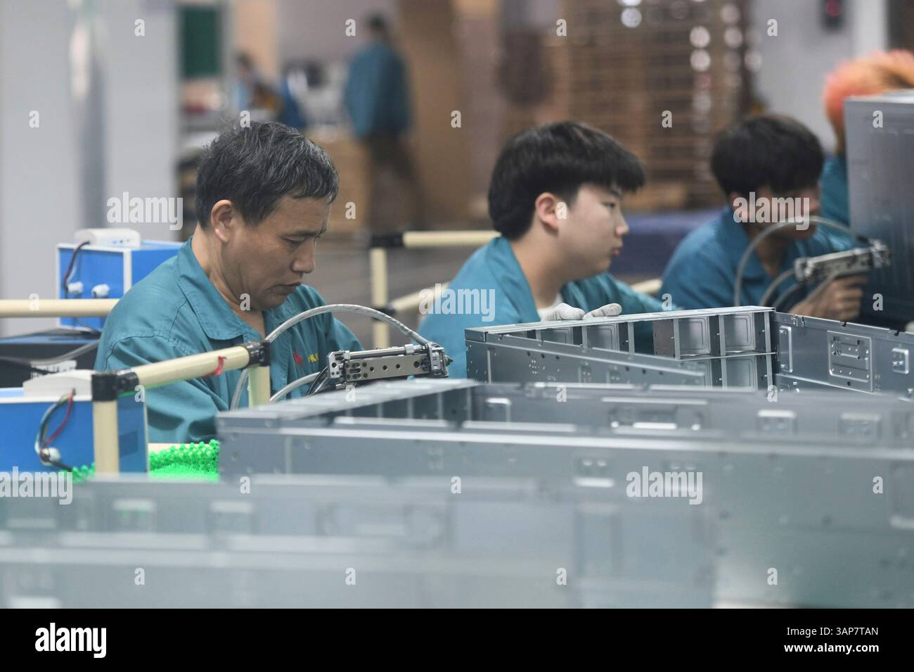 Workers assemble high-performance server chasis at a factory in ...