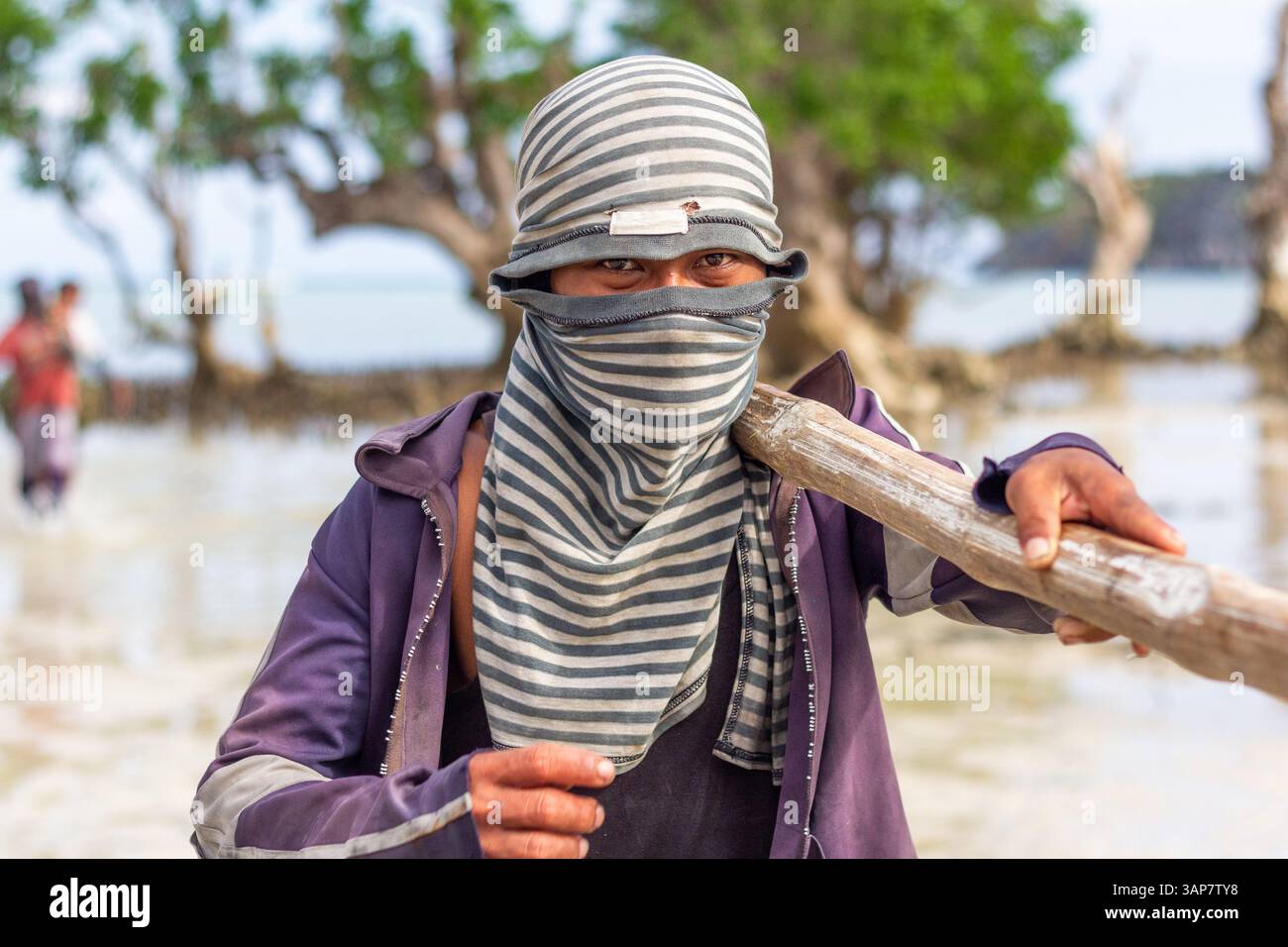Filipino fishermen transporting harvested scallop shells from boat to ...