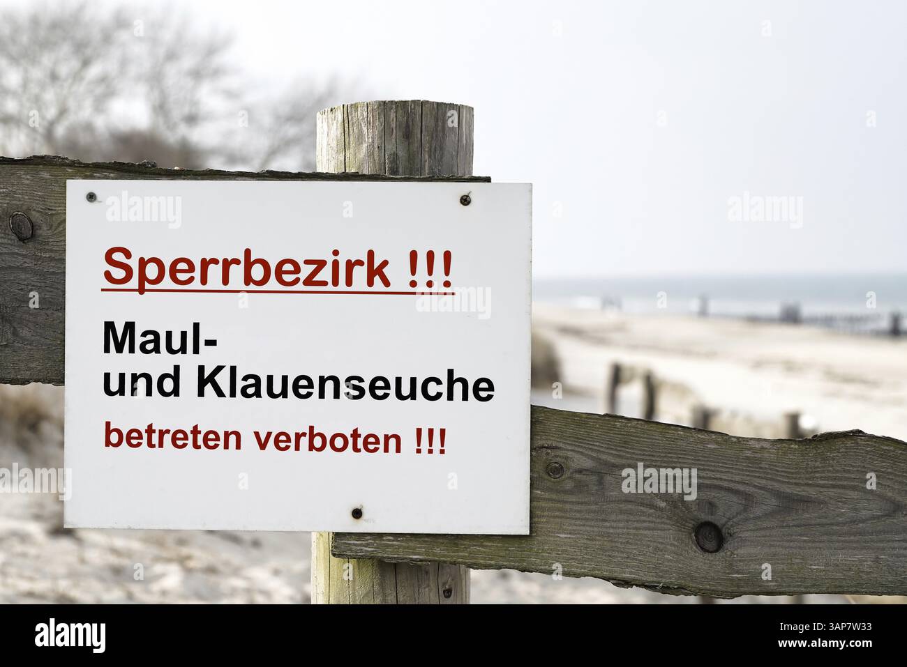 Sign with the German inscription Maul und Klauenseuche, trespassing ...