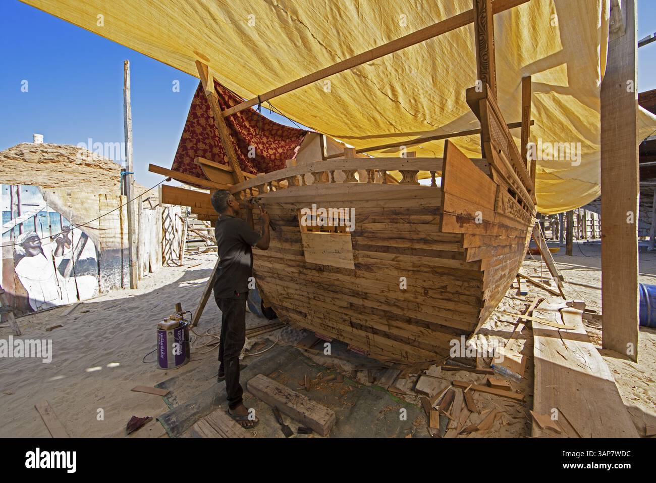 Indian man working at a dhow shipyard in Sur, Janub ash-Sharqiyya ...