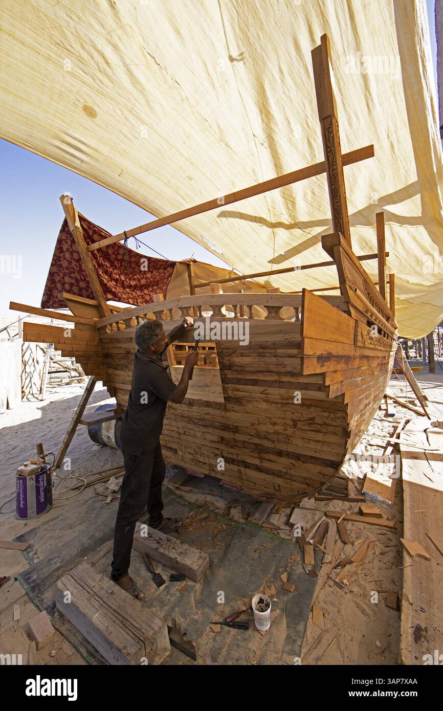 Indian man working at a dhow shipyard in Sur, Janub ash-Sharqiyya ...