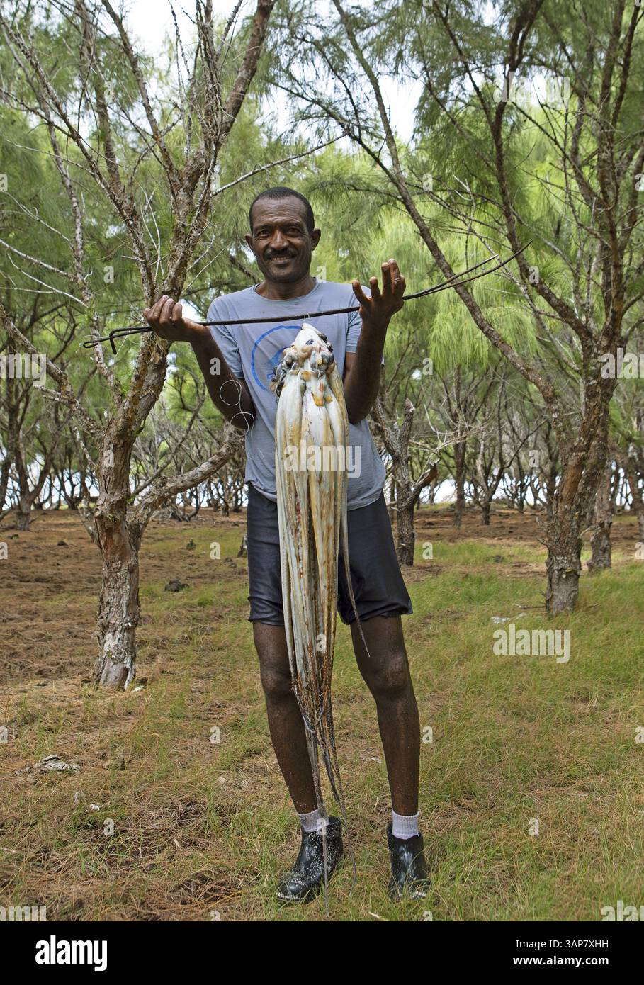 Mauritian man with an octopus, Rodrigues Island, Mauritius, Africa ...
