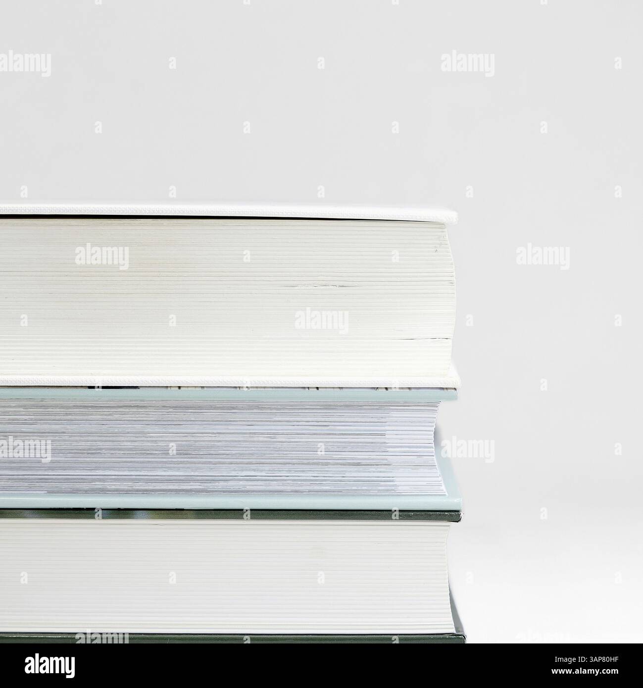 Three thick books with a white background Stock Photo - Alamy