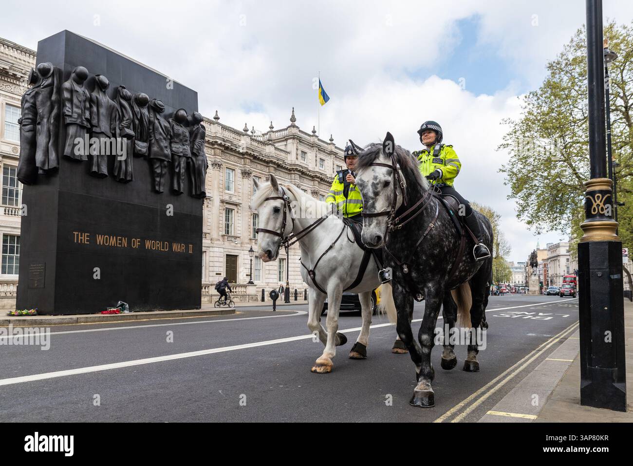 Metropolitan police mounted police officers riding past the Women of ...