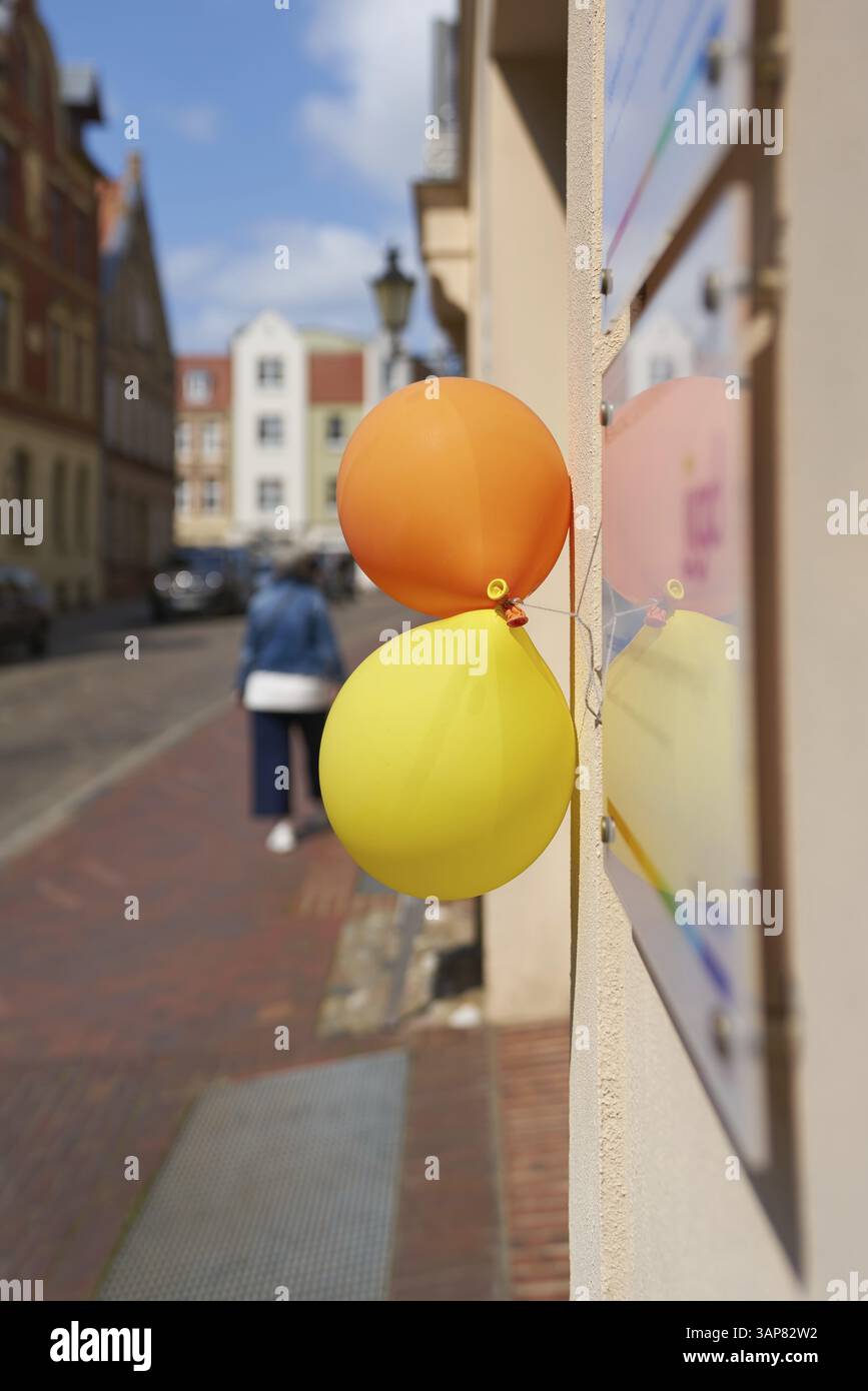 Balloons to mark a company anniversary on the facade of a commercial ...