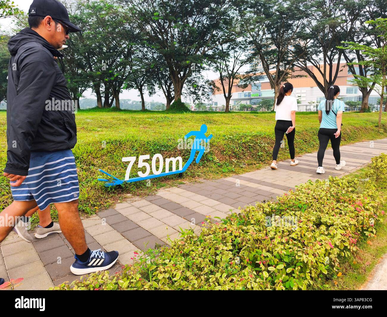Signpost at point 750 m on the running track passed by residents who ...