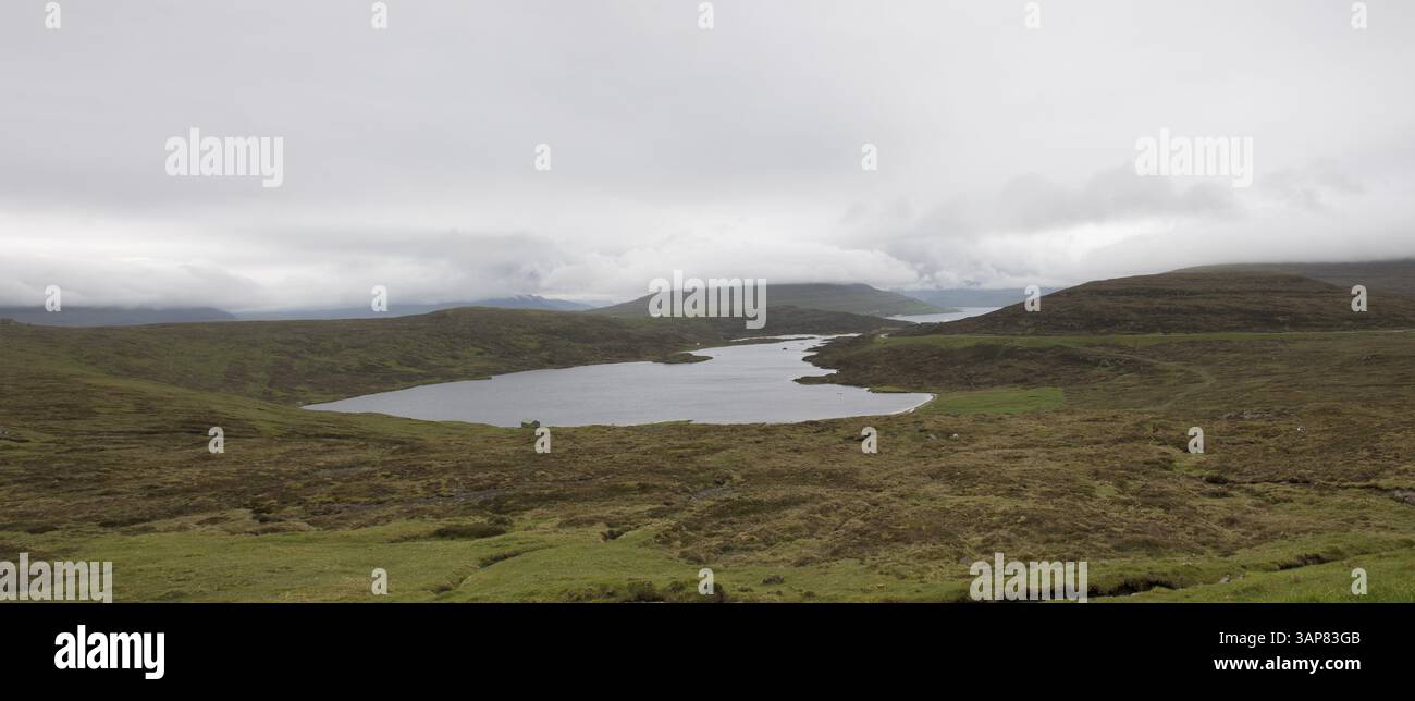 Landscape on the Faroe Islands with lake, fjord and clouds, Faroe ...