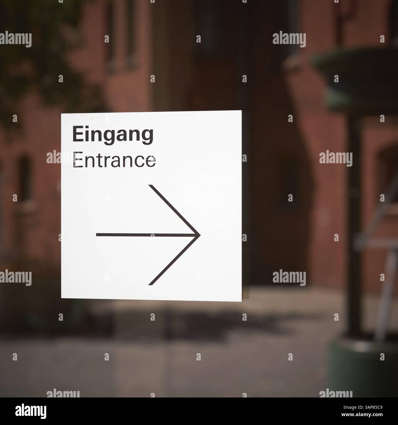 Sign with directional arrow for an entrance at a shop window Stock ...