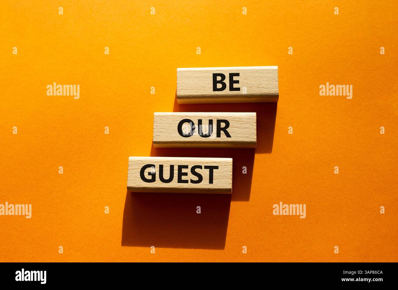 Be our guest symbol. Concept word Be our guest on wooden blocks ...