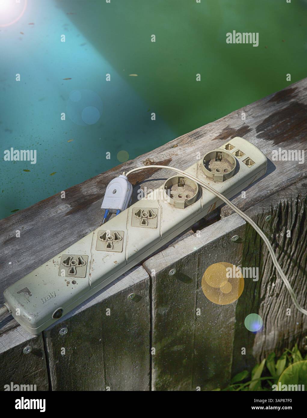 Risk of electric shock, a multiple socket outlet on the edge of a pool ...