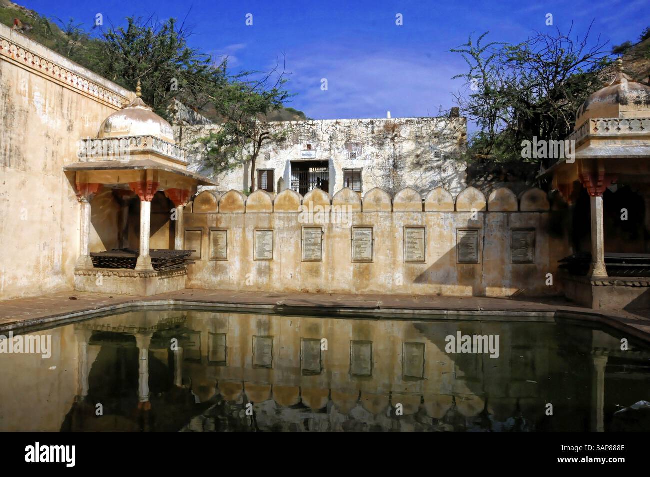 Temple, Galta Gorge, A historic palace is reflected in a tranquil pool ...