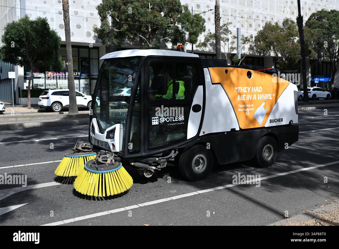 White and orange Bucher street sweeper, operated by Spotless, a Downer ...