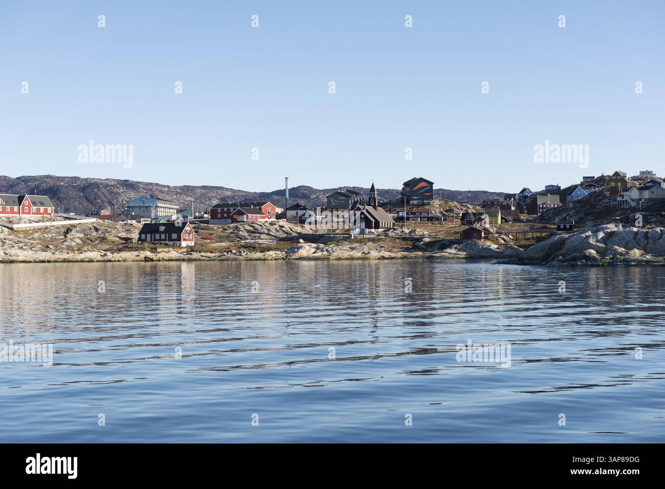 City view of Ilulissat in Greenland with colorful houses, mountains and ...