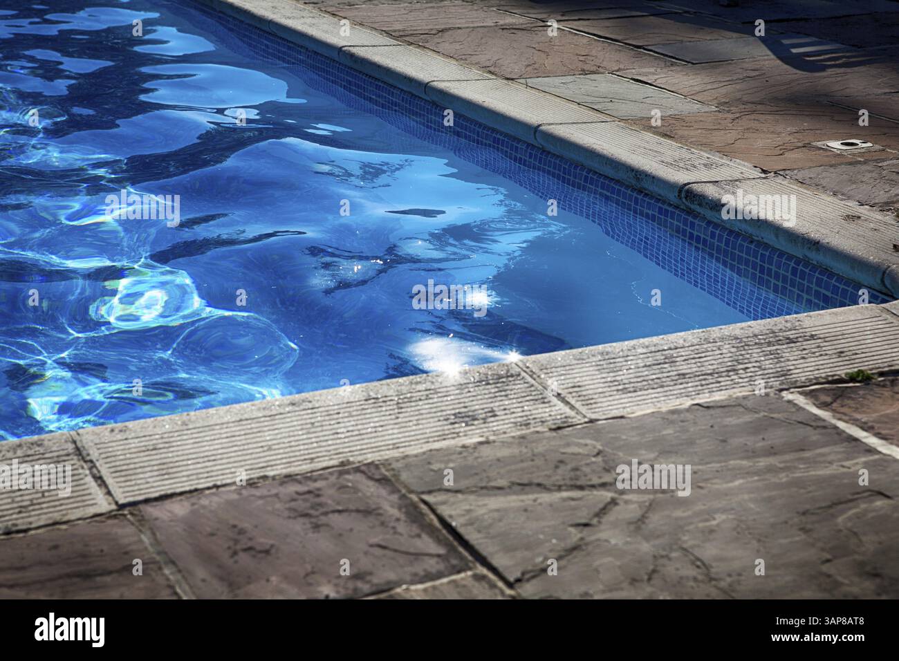 Pool edge of an outdoor pool Stock Photo - Alamy