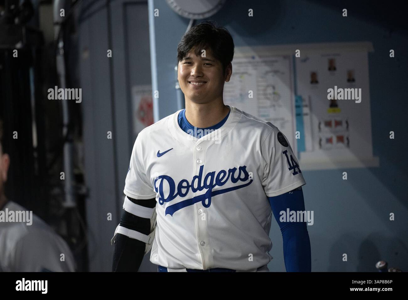 Los Angeles Dodgers' Shohei Ohtani smiles in the dugout during a ...