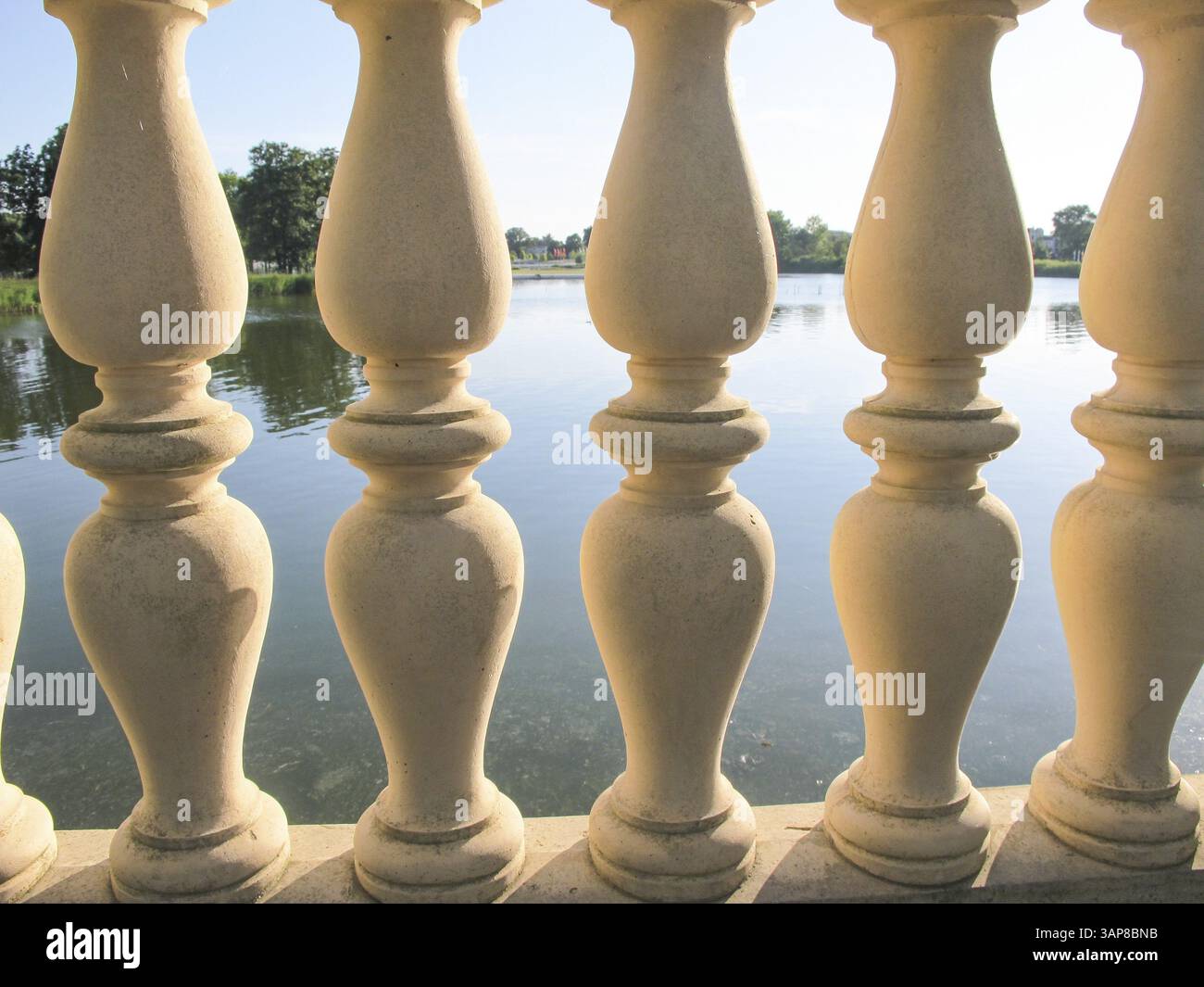 Close up detail of balustrade with beige sandstone Columns and lake ...
