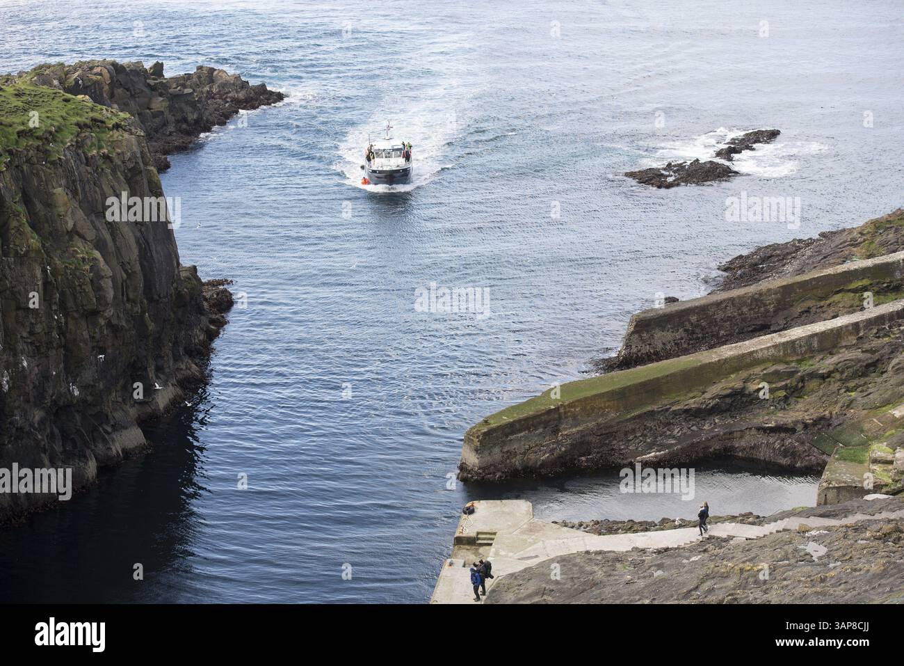 Post boat Josup arriving at Mykines island harbor on the Faroe Islands ...