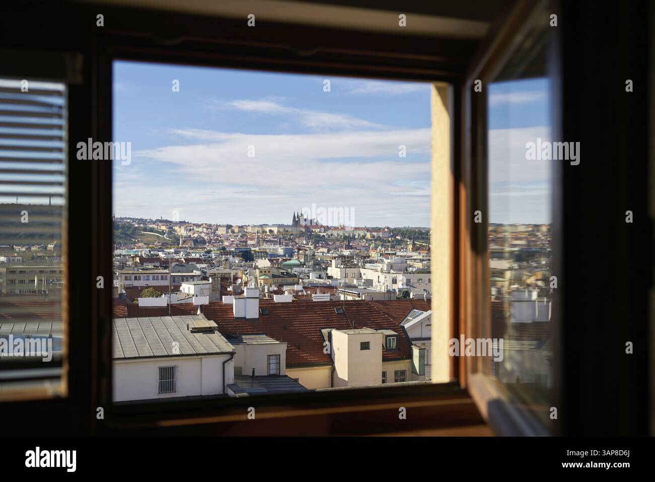 View through the open window over the historic centre of Prague with ...