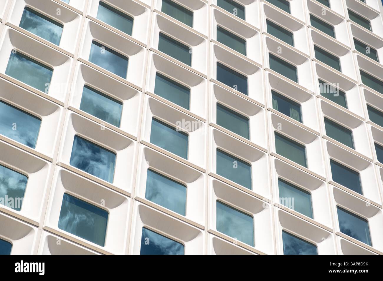 A detailed view of a building facade featuring a repetitive pattern of ...