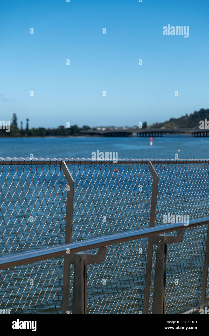 A railing of Elizabeth Quay Bridge, with a view of South Perth in Perth ...