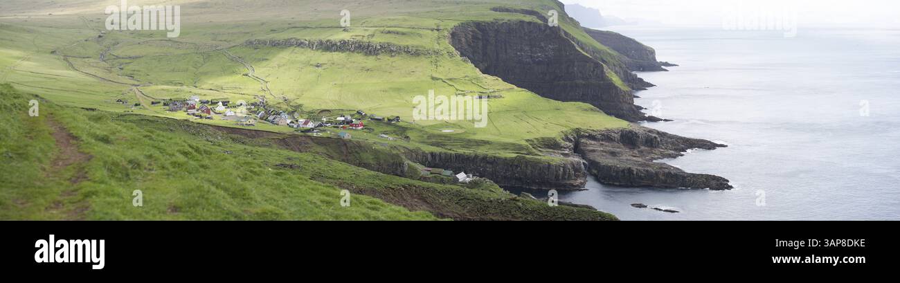 Panorama of the village Mykines on the Faroe Islands with cliff blue ...