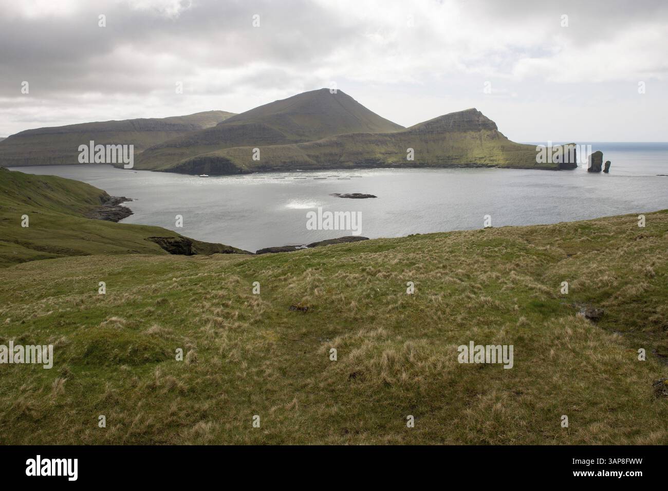 Cliffs on Vagar Island on the Faroe Islands with salmon farm, Faroe ...