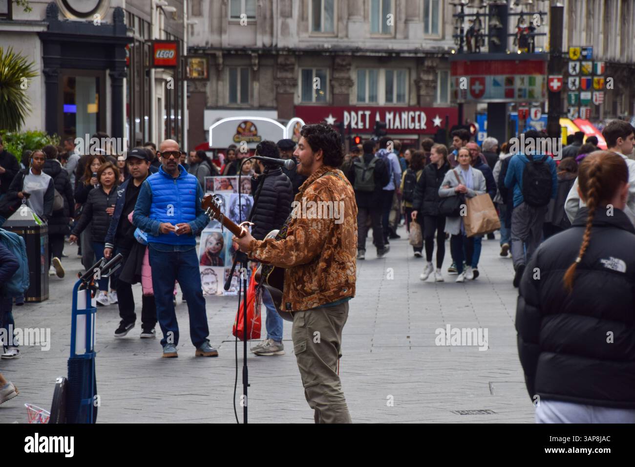 London, England, UK. 15th Apr, 2025. A busker performs in Leicester ...