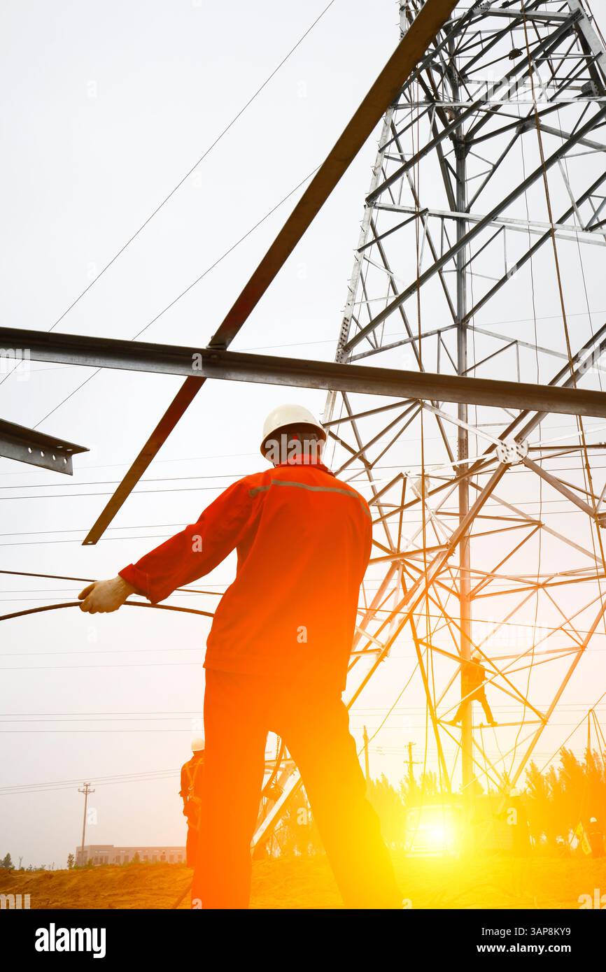 The workers of the pylon Stock Photo - Alamy