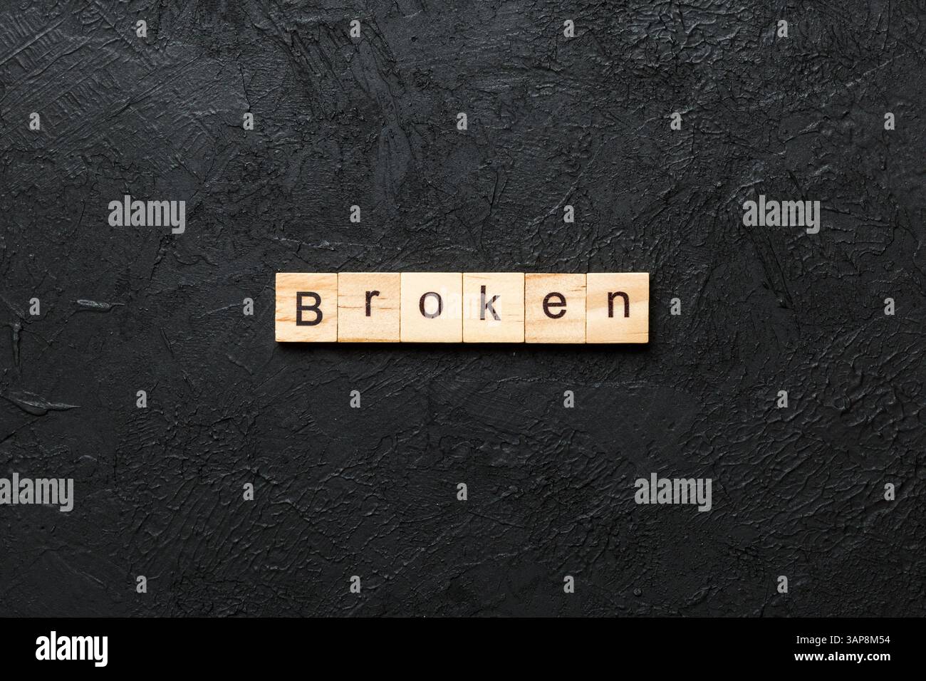 BROKEN word written on wood block. BROKEN text on cement table for your ...