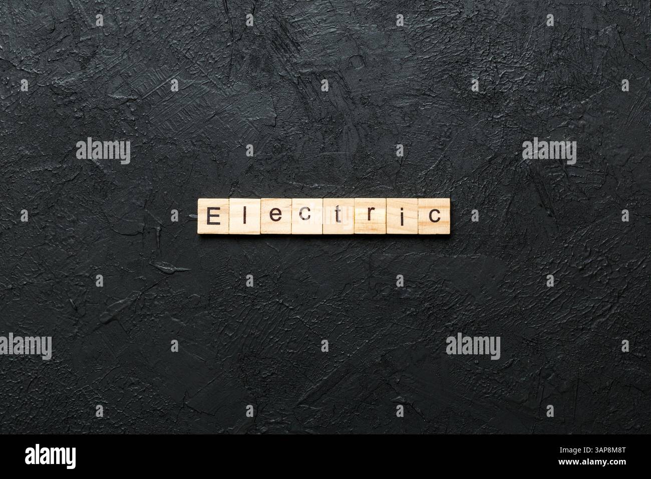 Electric word written on wood block. Electric text on cement table for ...