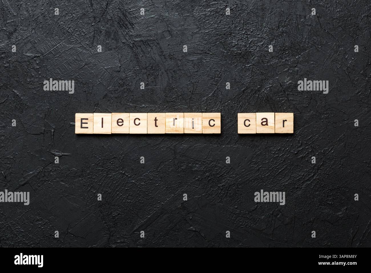 Electric Car word written on wood block. Electric Car text on cement ...