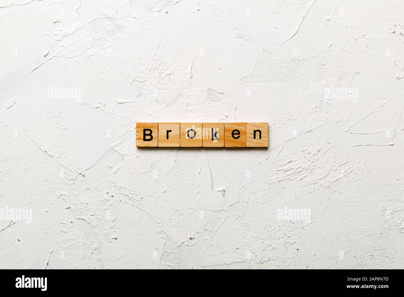 BROKEN word written on wood block. BROKEN text on cement table for your ...