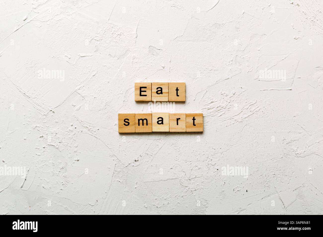 Eat smart word written on wood block. Eat smart text on cement table ...