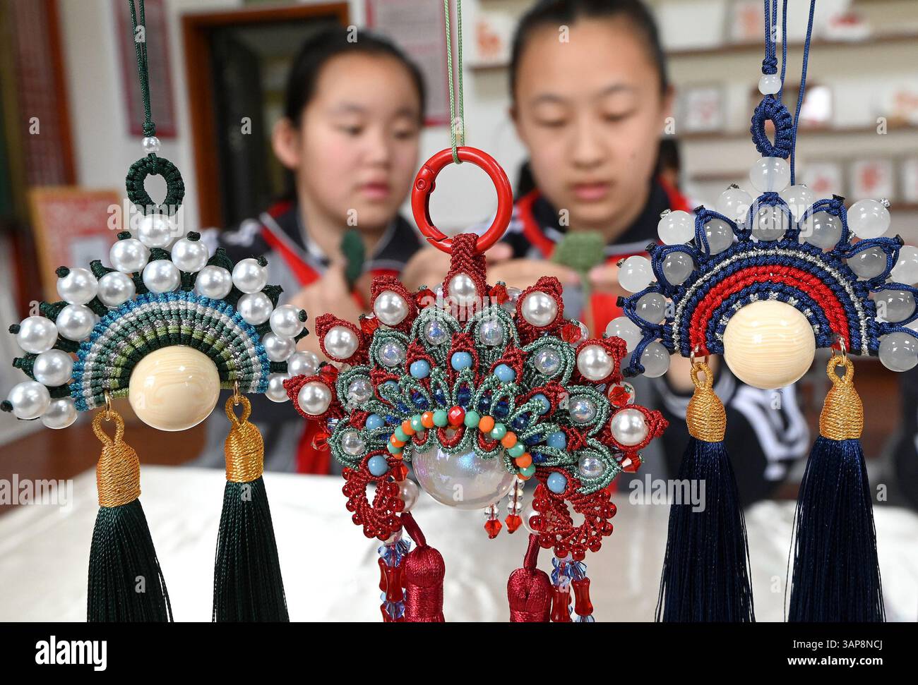 HANDAN, CHINA - APRIL 16, 2025 - Students weave knot crafts at Railway ...