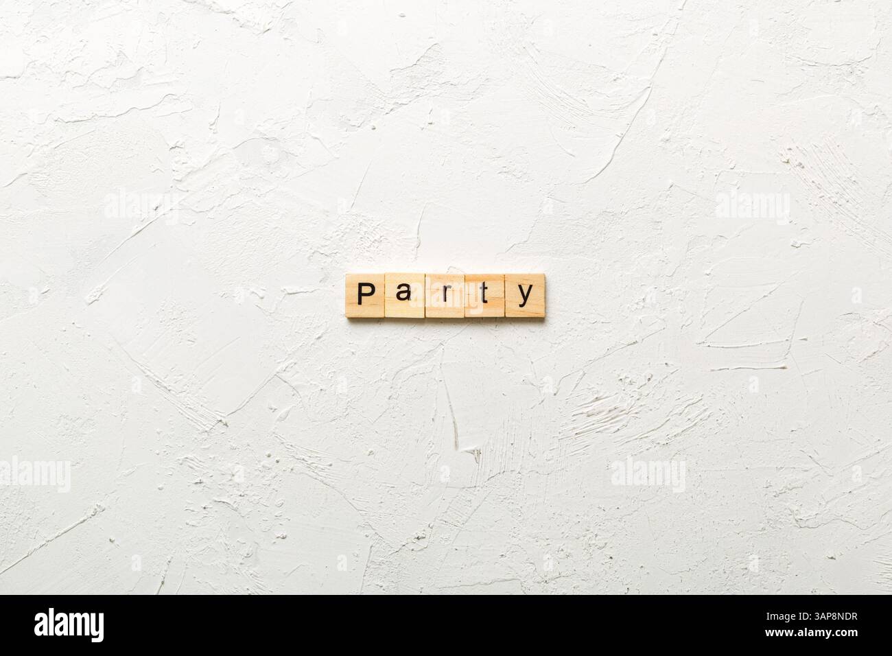PARTY word written on wood block. PARTY text on cement table for your ...