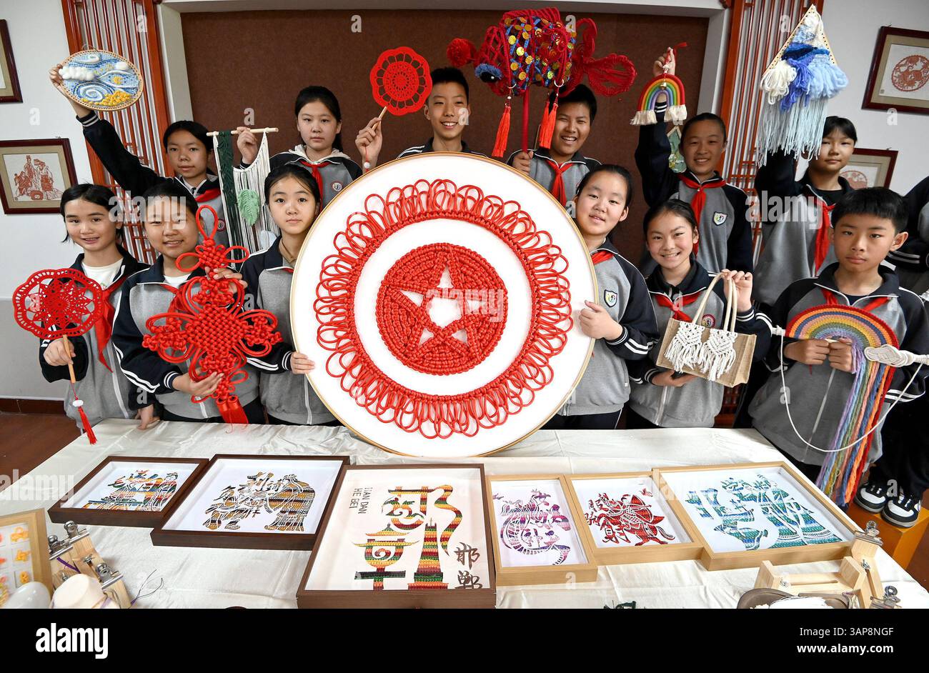 HANDAN, CHINA - APRIL 16, 2025 - Students weave knot crafts at Railway ...