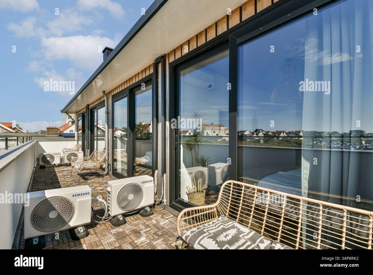 A sleek and modern balcony featuring air conditioning units, stylish ...